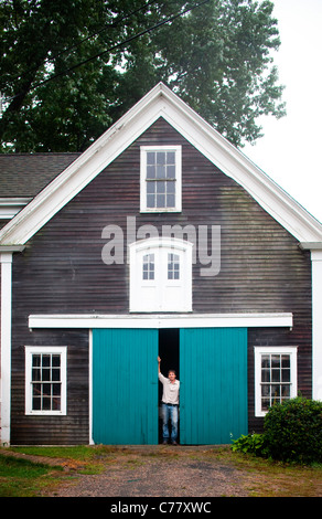 An old barn standing alone in the field of a farm. Rustic, weather-worn ...