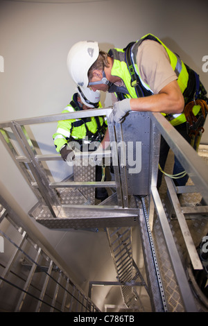 Engineer inside the nacelle of a wind turbine at Caton Moor wind farm ...