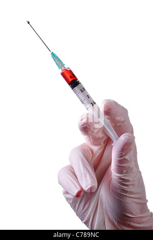 Hand holding syringe with red liquid Stock Photo - Alamy