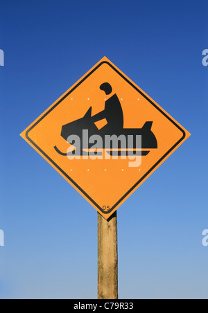 Yellow road sign for Skidoo or Snowmobile trail, with blue sky ...