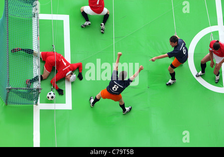 Football players hanging on ropes are pictured at a vertical football ...