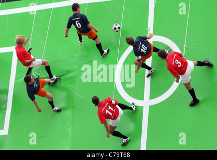 Football players hanging on ropes are pictured at a vertical football ...