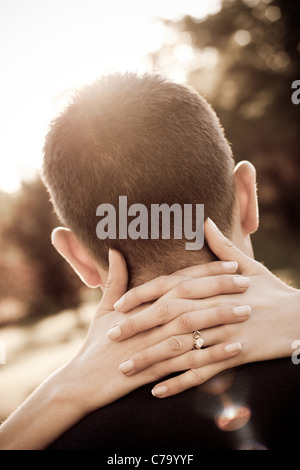 A female hands around the neck of her fiance - engagement photos Stock ...
