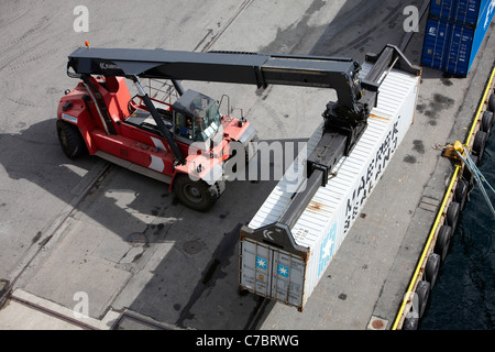A ship's cargo container being moved in the port of Bergen, Norway ...