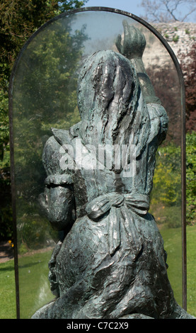 Bronze sculpture of Alice looking through the looking glass by Jean ...