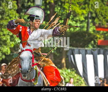 An Archer in Samurai Clothing prepares to shoot in a Horseback archery ...