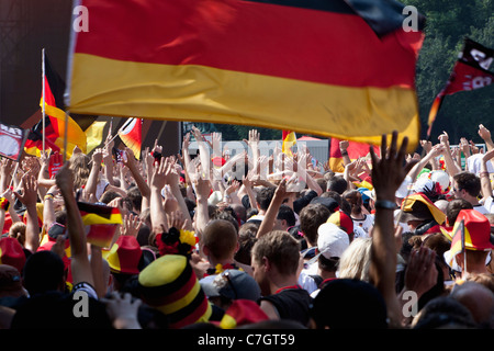 Detail of people in a crowd waving German flags Stock Photo - Alamy