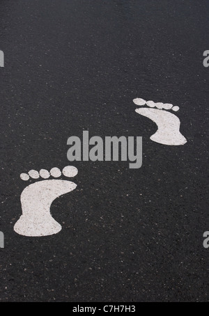 Painted footsteps on a pavement Stock Photo - Alamy