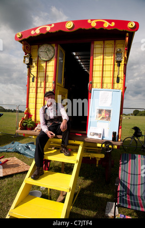 Traditional gypsy caravan with Romany sitting inside Stock Photo - Alamy