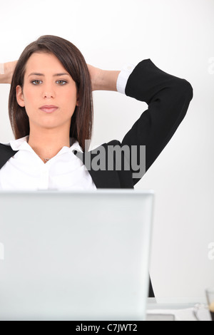 Woman leaning back from her laptop computer Stock Photo - Alamy