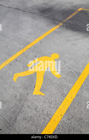 Yellow pedestrian road safety walkway sign painted a road in a car ...
