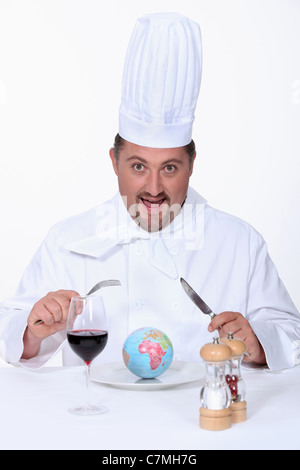 Chef eating planet earth Stock Photo - Alamy