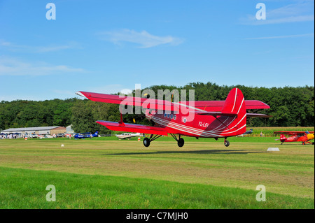 Biplane landing on the grass Stock Photo - Alamy