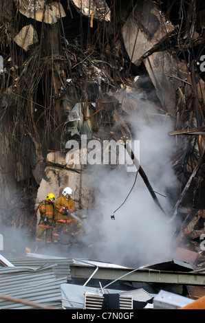 Firefighters work to douse a fire at a shopping mall in Jammu, India ...