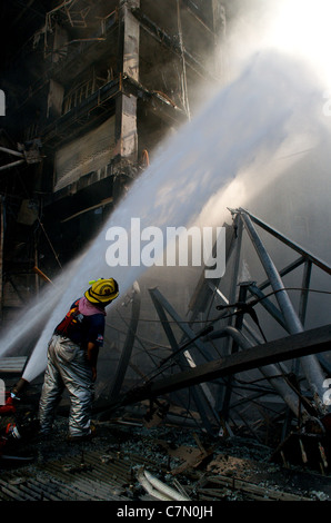 Firefighters work to douse a fire at a shopping mall in Jammu, India ...