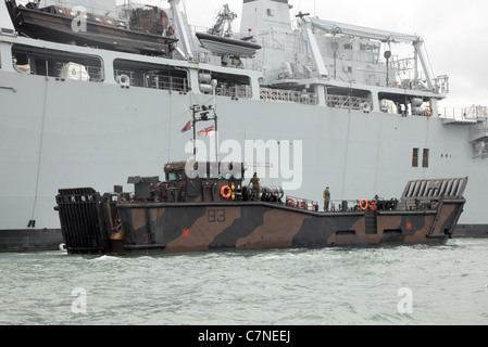 A Royal Marines landing craft (LCU 10, Landing Craft Utility Mk 10) with a load of vehicles ...