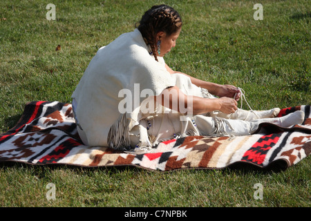 Native American Indian woman tying her moccasins Stock Photo - Alamy