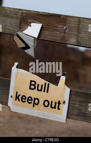 A vertical sign warning attached to a fence indicating Authorised ...