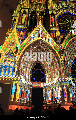Reims cathedral at night illuminated by projected coloured lights ...