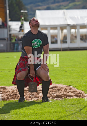 Gregor Edmunds, heavyweight athlete and strong man throwing the weight ...