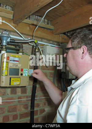 man using a quantum key prepayment electric meter, paying for ...