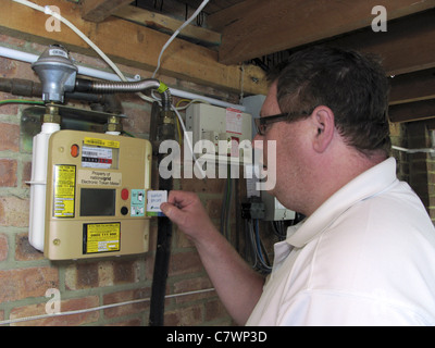 man using a quantum key prepayment gas meter & checking the amount of ...