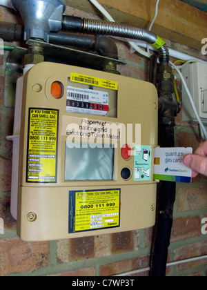 man using a quantum key prepayment electric meter, paying for ...