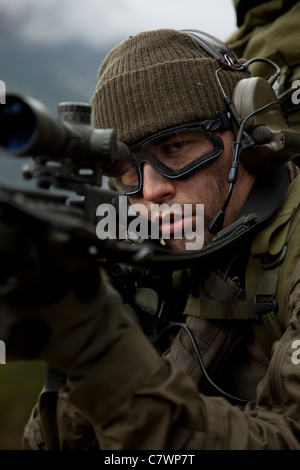 U.S. special forces soldier stays alert while wearing a radio headset ...