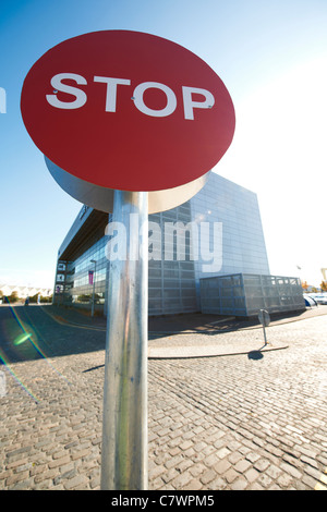 Red circular stop sign against urban scene Stock Photo - Alamy