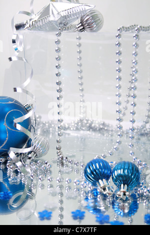 A lovely blue baubles on a mirror surface with ribbons and beads Stock ...