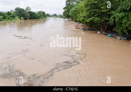 Flood debris floating down the River Severn passing the Haw Bridge Inn ...