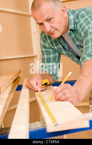 Handyman home improvement close-up of measure wooden board with ruler ...