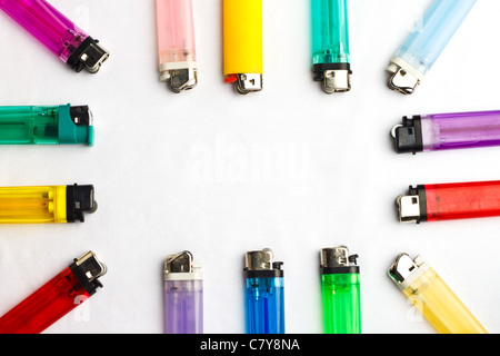 Variety of lighters against a white background including a gas lighter ...