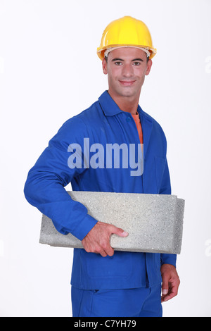 Male stone mason repairing brickwork repointing joint mortar cement ...