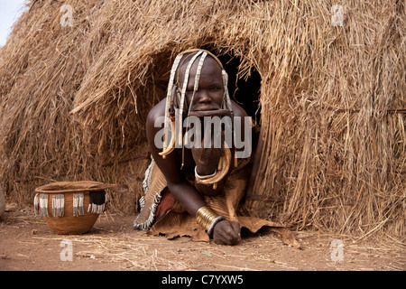 Mursi Woman Sitting Outside A House, Jinka, Omo Valley, Ethiopia Stock ...