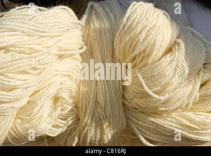 Needle and white cotton, tangled yarn on roll for sewing. Thread used ...