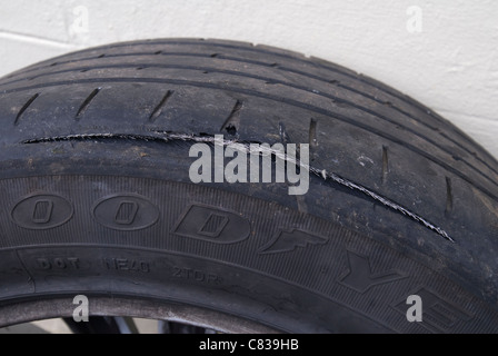 Split in run flat tyre exposing steel belting Stock Photo - Alamy