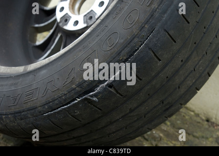 Split in run flat tyre exposing steel belting Stock Photo - Alamy