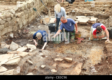 Student archaeologist digging at an excavation at Fort Mose ...