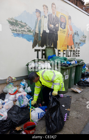 Workmen clear up rubbish left outside the Liver building in Liverpool ...