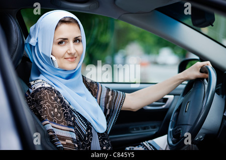 smiling woman driving while phoning Stock Photo - Alamy