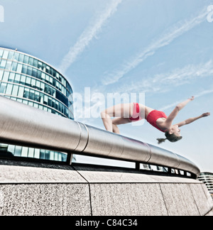 Athlete vaulting over stone wall Stock Photo - Alamy