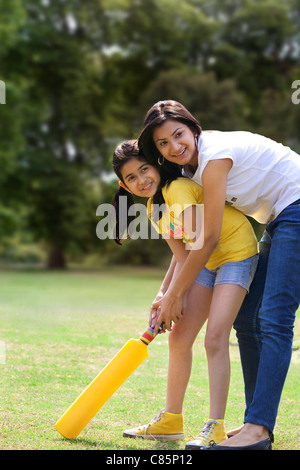 indian Parents with child park Playing Cricket Stock Photo - Alamy