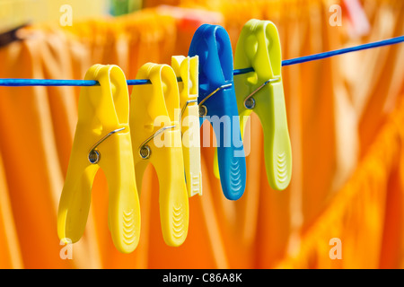 Washed clothes drying outside with cloth pegs Stock Photo - Alamy