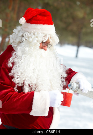 Santa Claus drinking hot tea or coffee and wishes Merry Christmas on ...