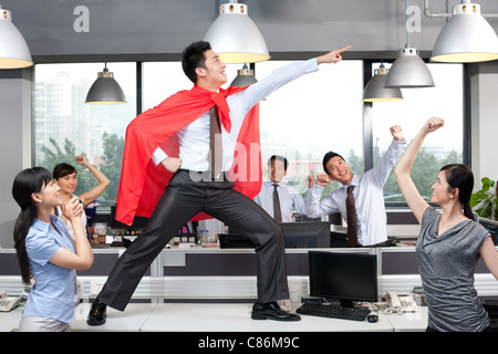 Colleagues Cheering On Superhero Stock Photo - Alamy