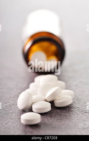 Overflowing Bottle of Pills Stock Photo - Alamy