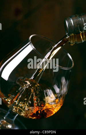 Pour into a glass for tasting brandy Stock Photo - Alamy