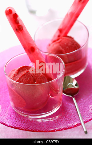 Raspberry ice cubes on pink glossy background Stock Photo - Alamy