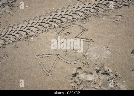 Fish drawn in the sand Stock Photo - Alamy